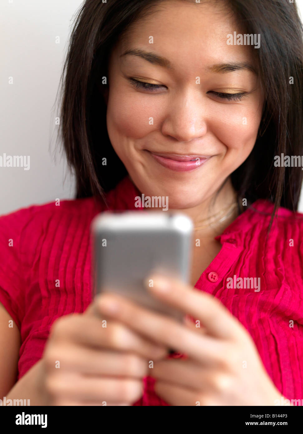 Young Asian women using mobile phone Stock Photo - Alamy