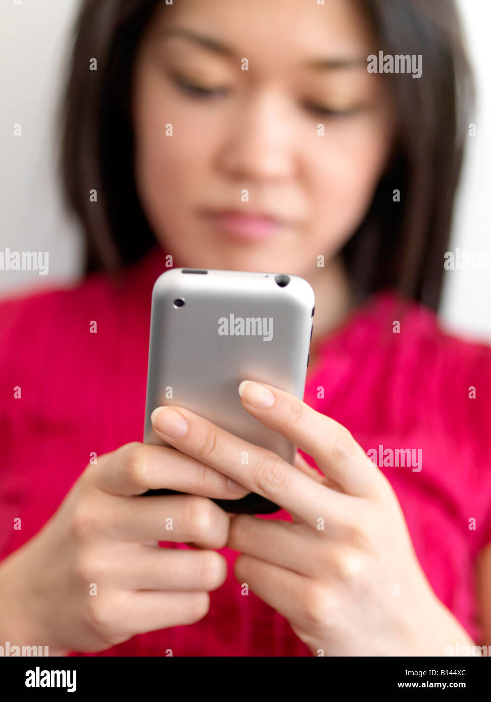 Young Asian women using a mobile phone Stock Photo - Alamy