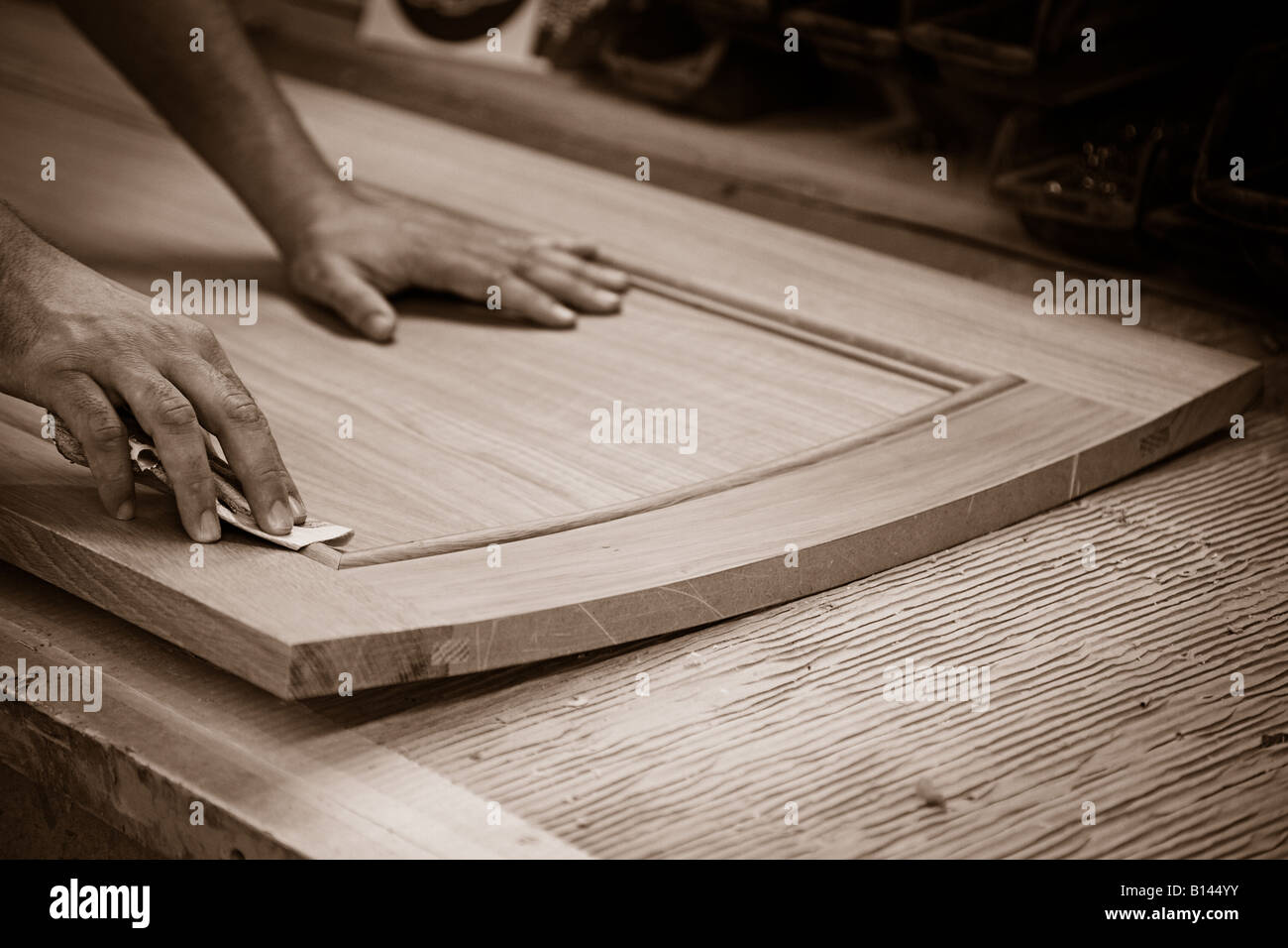 Craftsman sanding a curved wooden door in workshop Stock Photo - Alamy