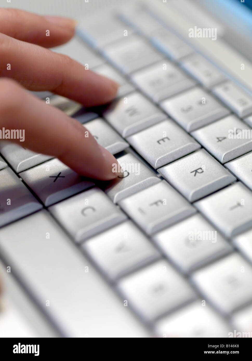 A woman's hand on a keyboard Stock Photo - Alamy