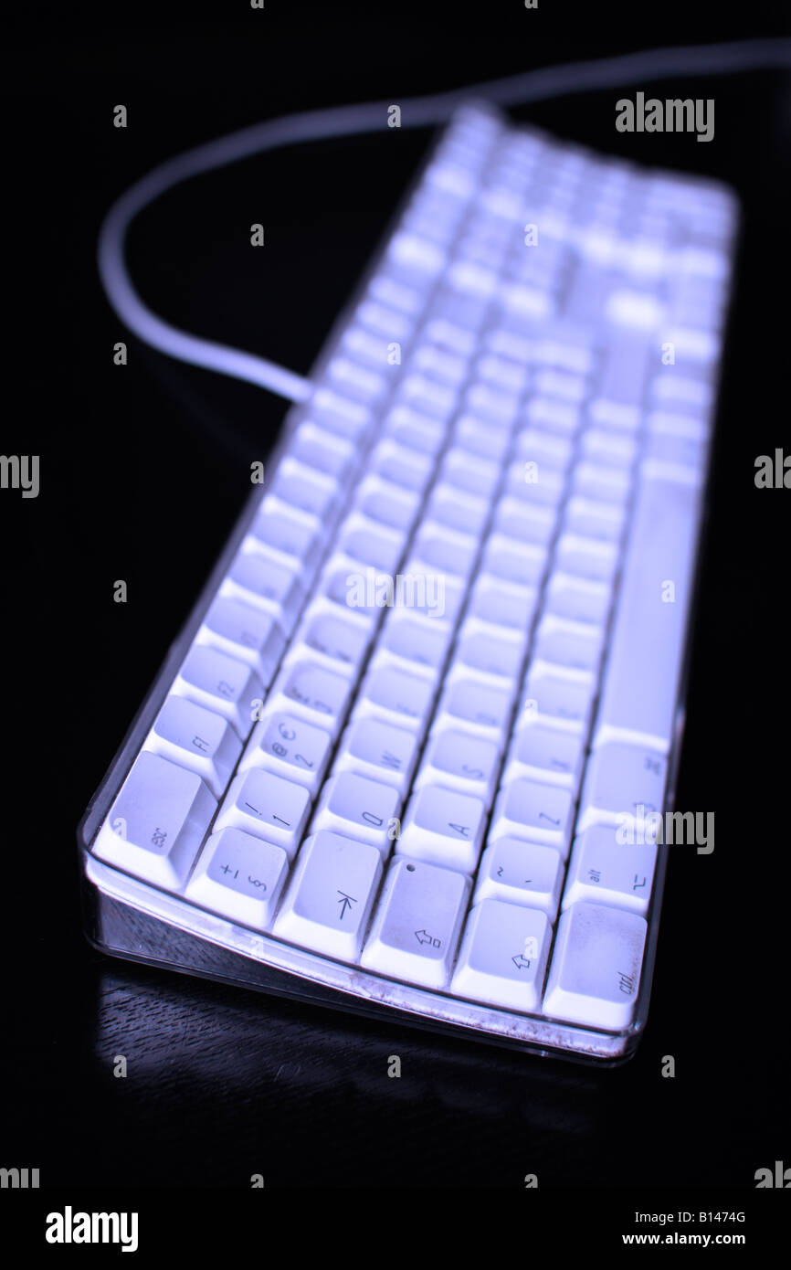 Computer keyboard, in a blue glow Stock Photo - Alamy