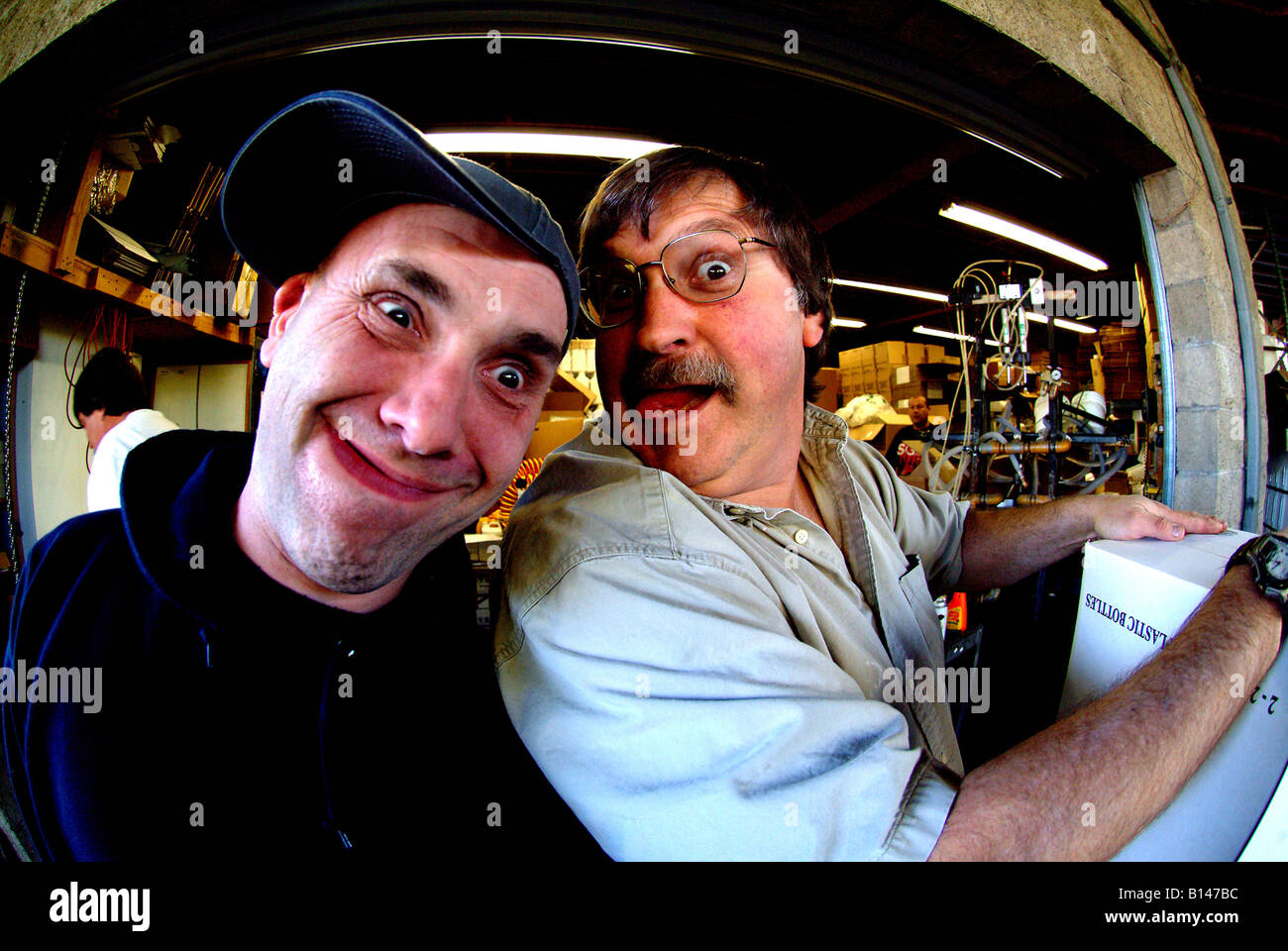 Two men pulling silly mad faces Stock Photo - Alamy