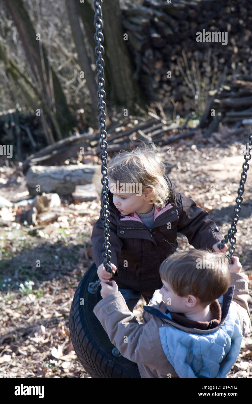 little children on a swing Stock Photo - Alamy