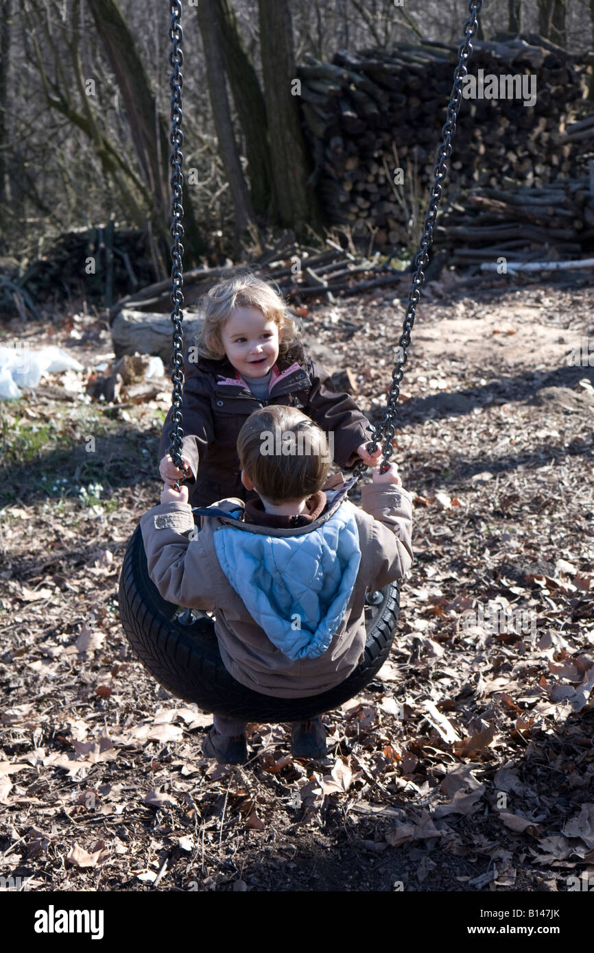little children on a swing Stock Photo - Alamy