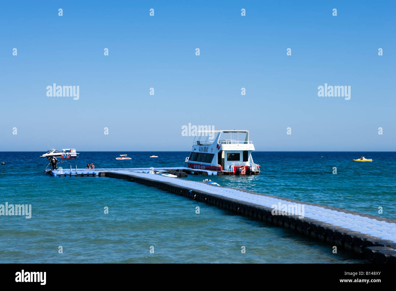 Glass Bottom Boat moored at a floating jetty, Naama Bay Beach, Sharm el ...