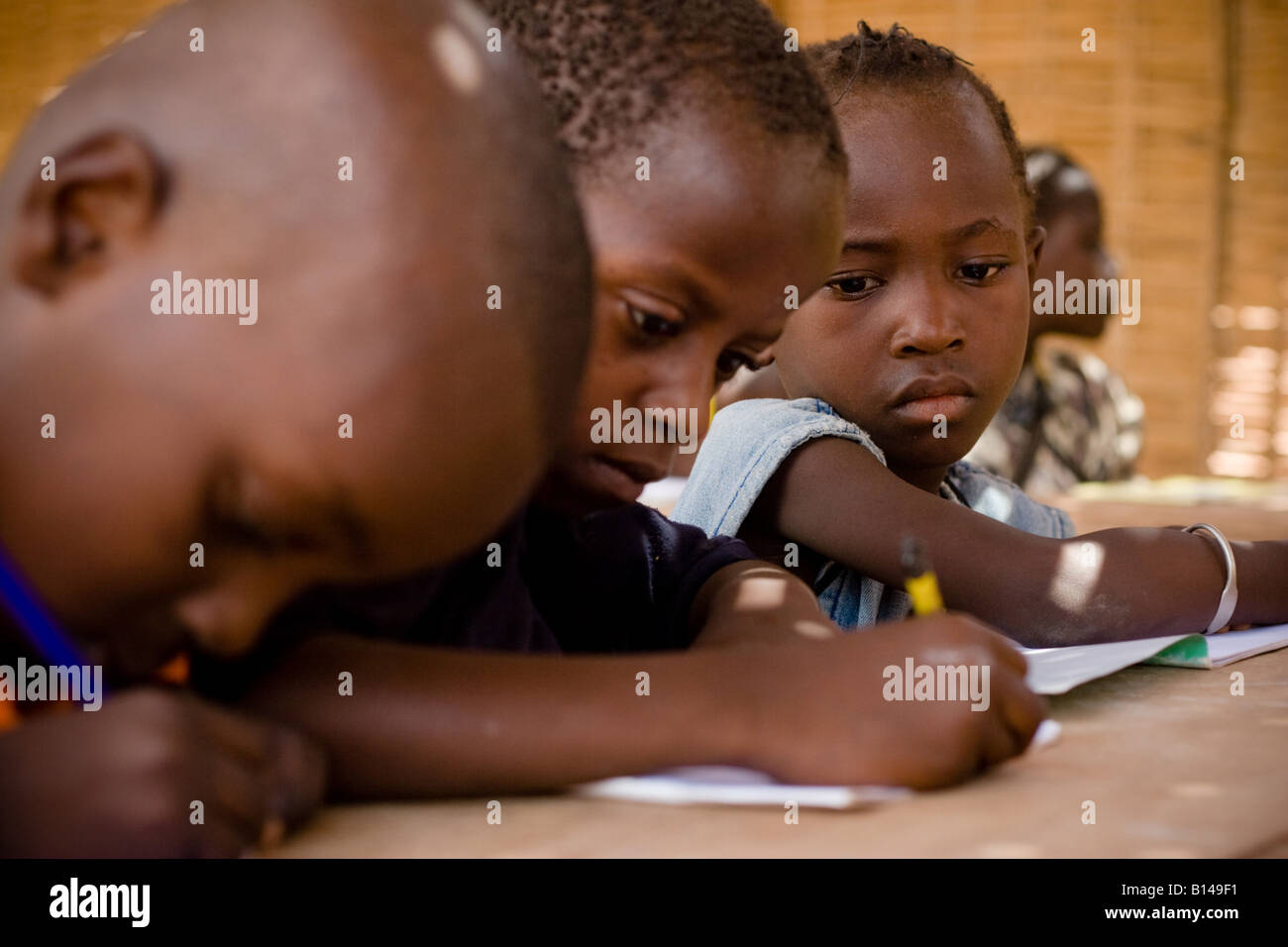 Children writing in their school books during class Stock Photo - Alamy