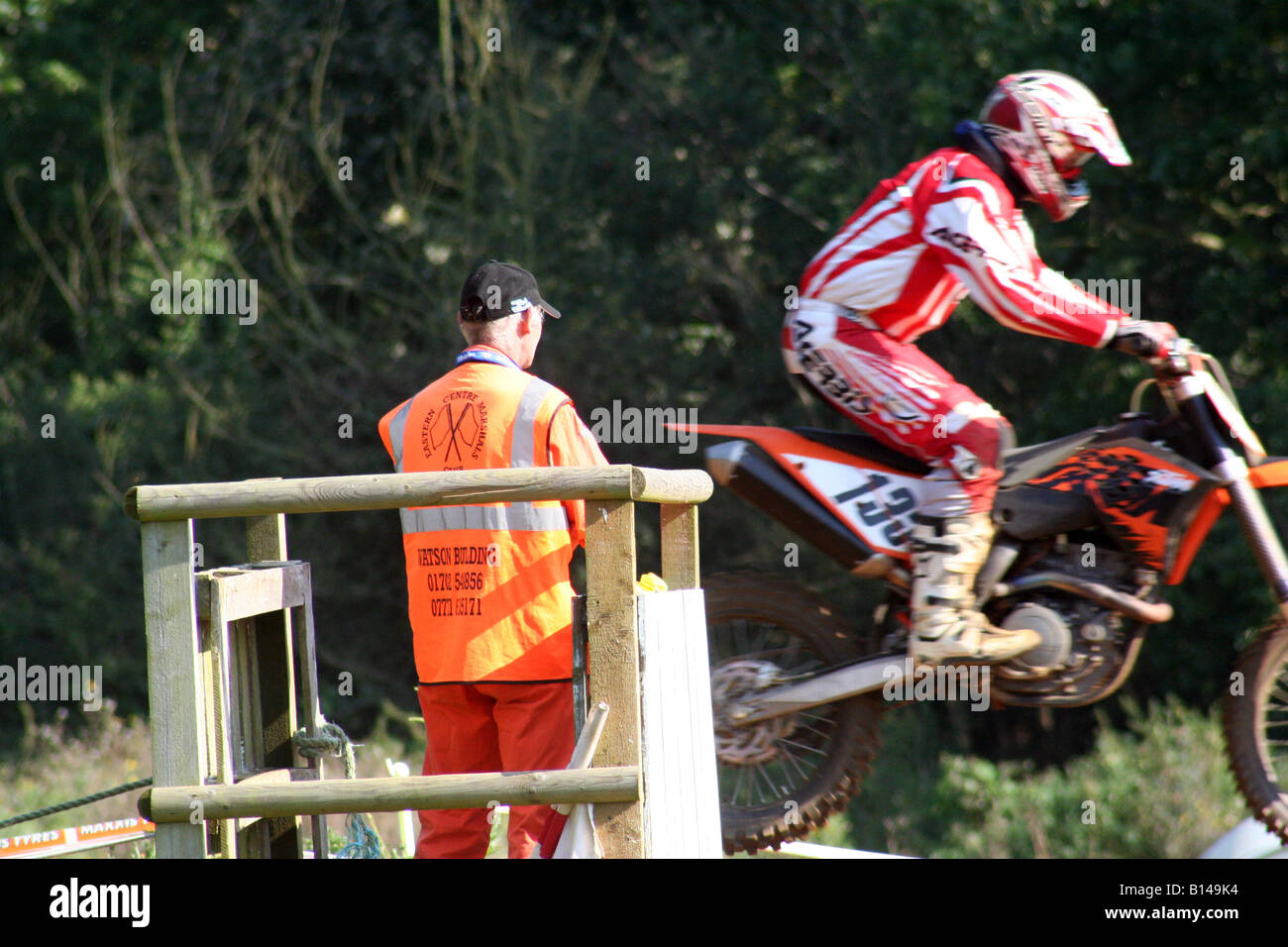At a motocross a race marshall watchs a racer pass Stock Photo - Alamy