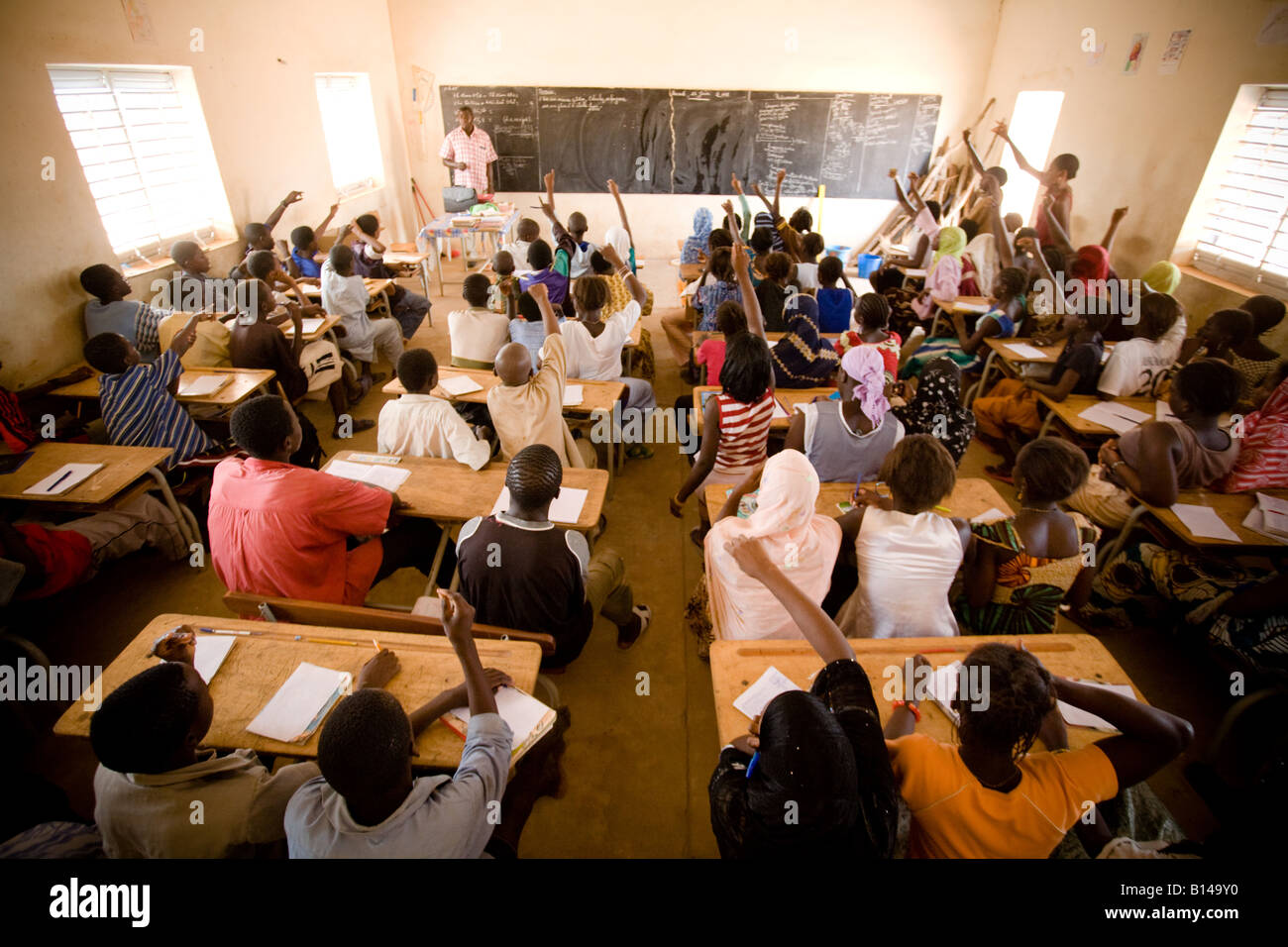 Children raise hands to answer a question during class Stock Photo - Alamy