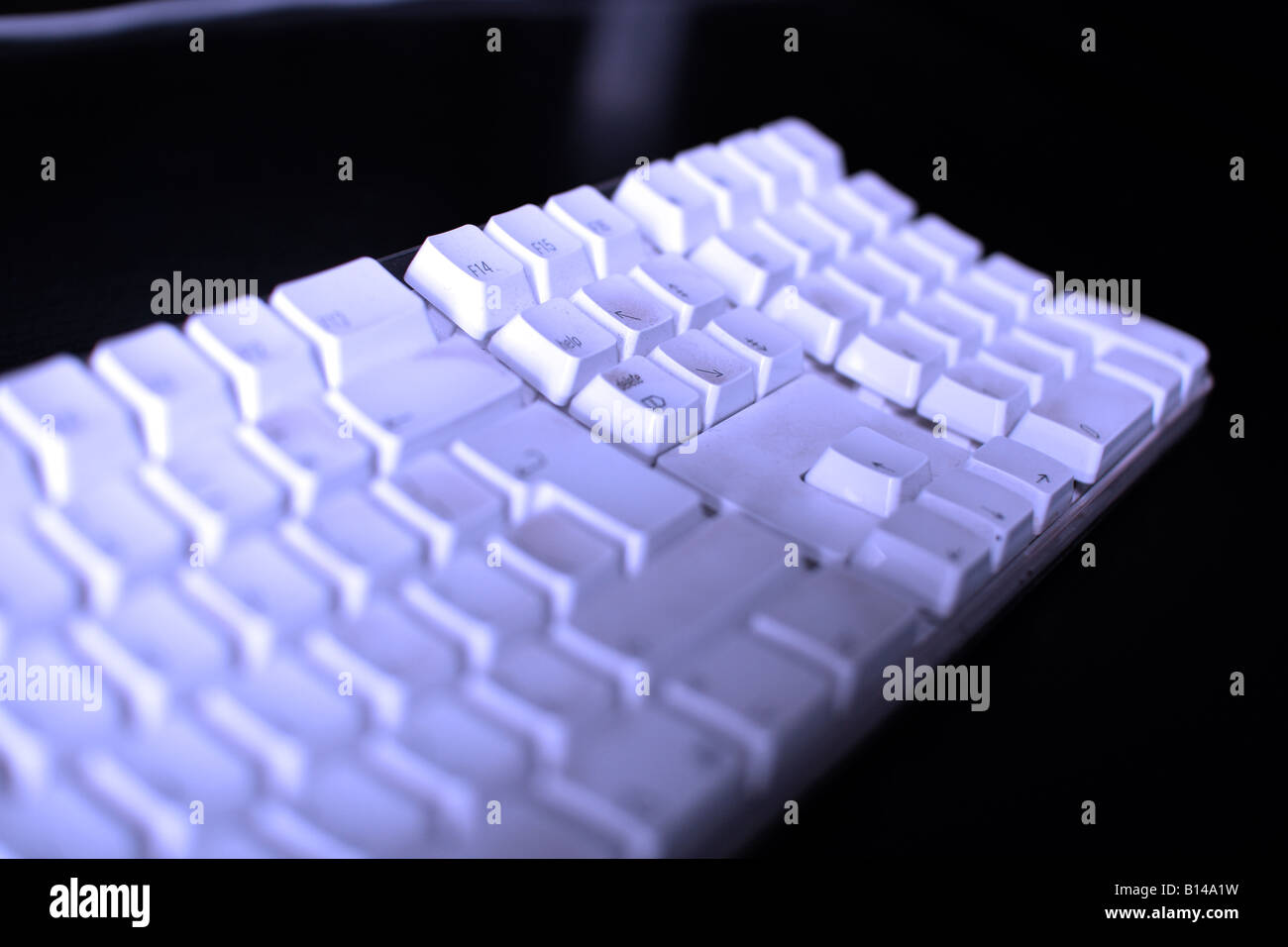 Computer keyboard, in a blue glow Stock Photo - Alamy