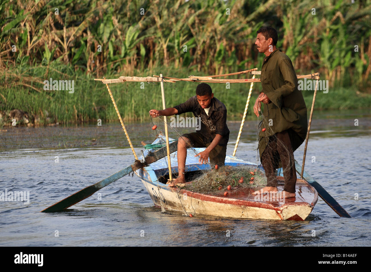 Egyptian fisherman with his son fishing in the Nile river at Cairo ...