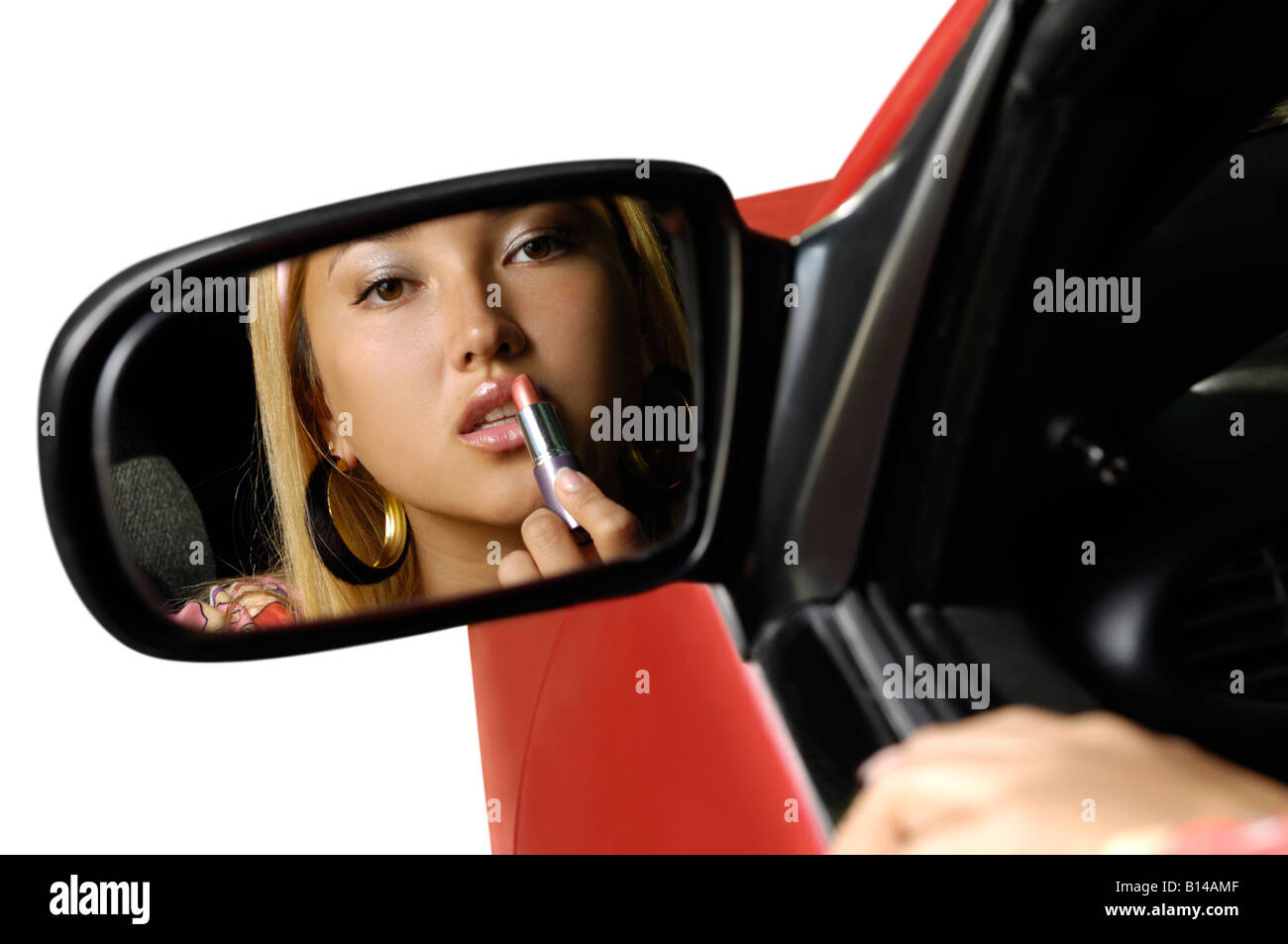 Woman applying lipstick in a car Stock Photo - Alamy