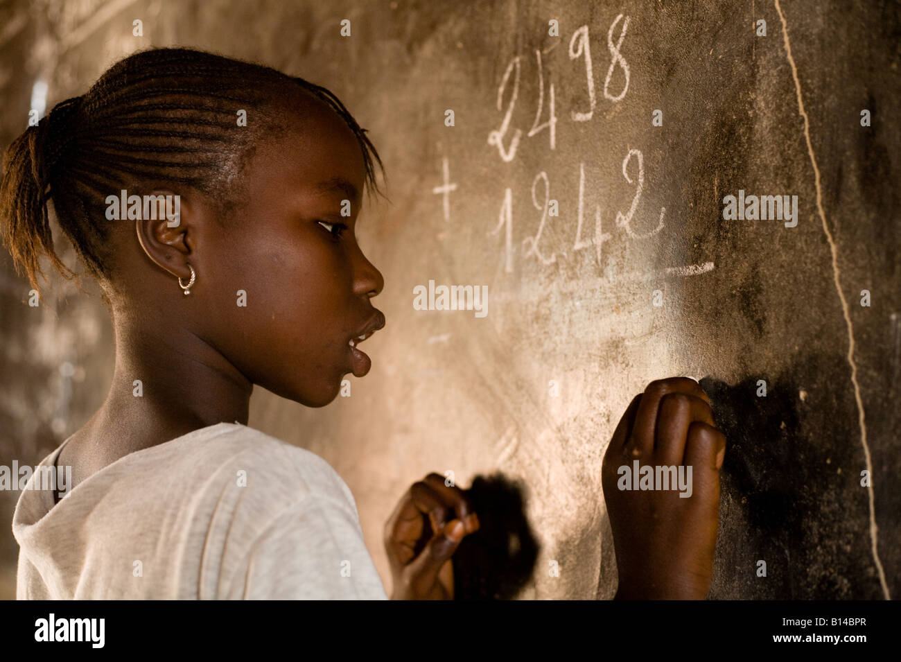 A girl solves a math problem during class Stock Photo - Alamy