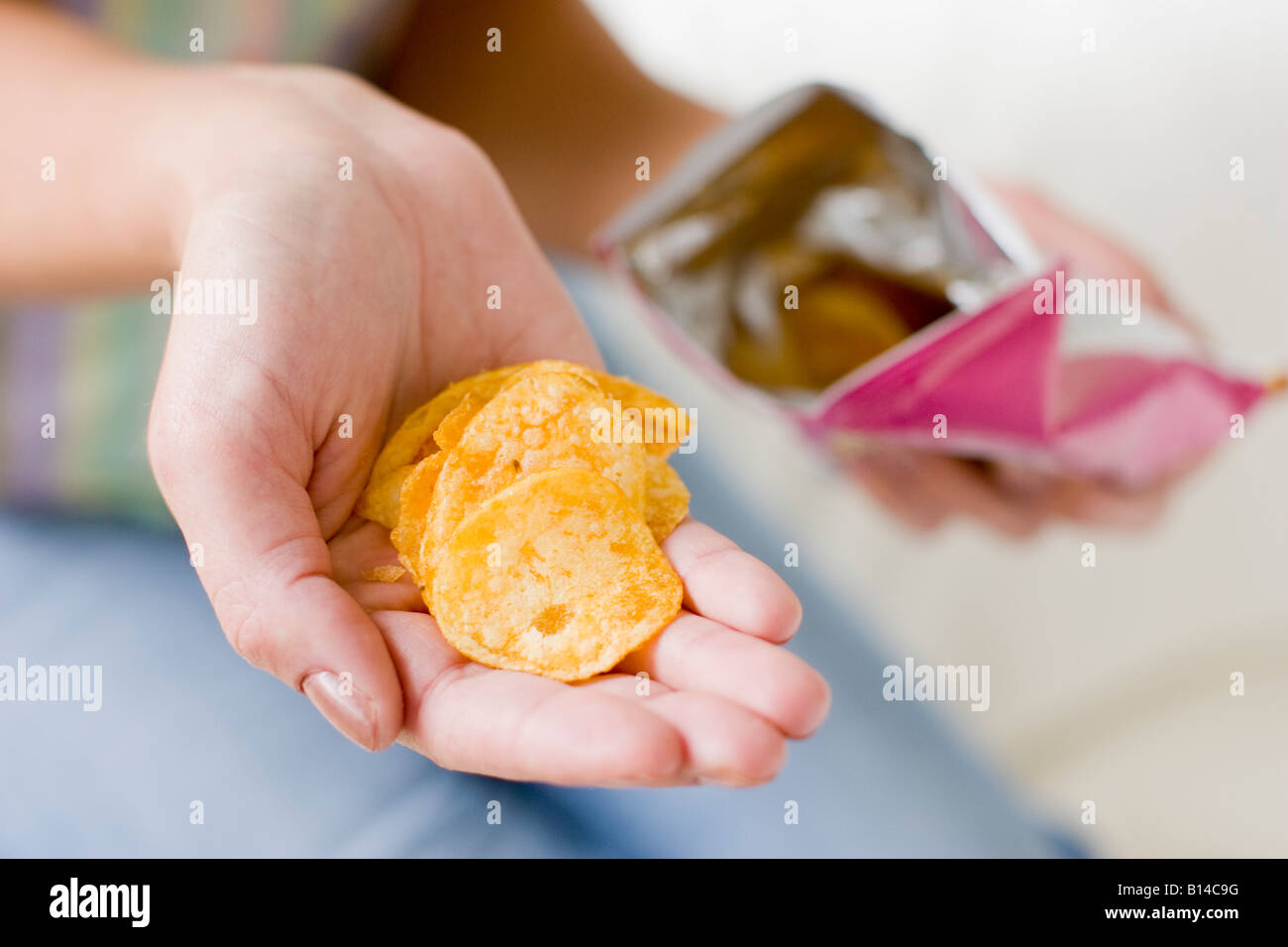 Holding packet of chips hi-res stock photography and images - Alamy