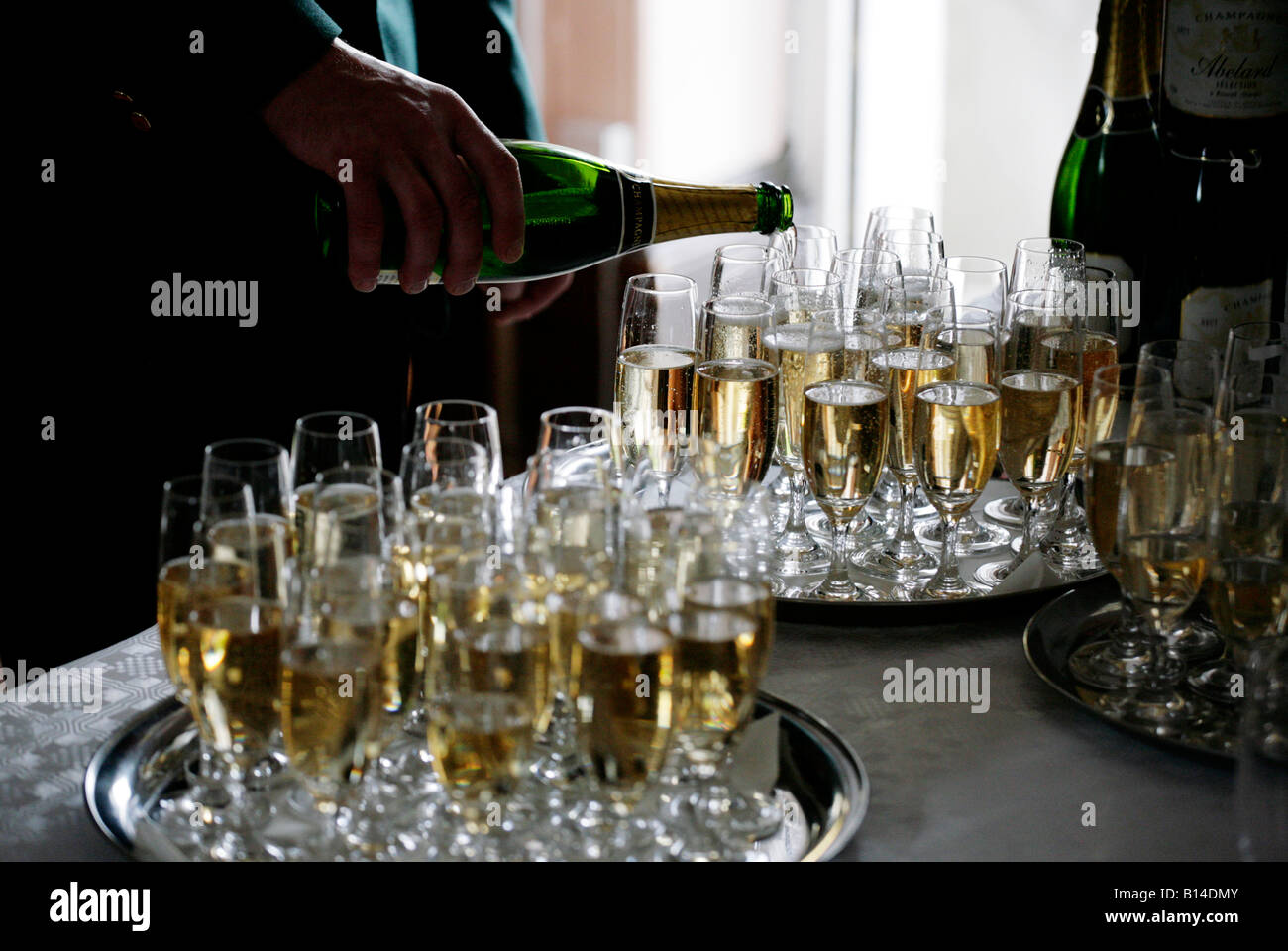 Champagne glasses being filled in the UK Stock Photo - Alamy