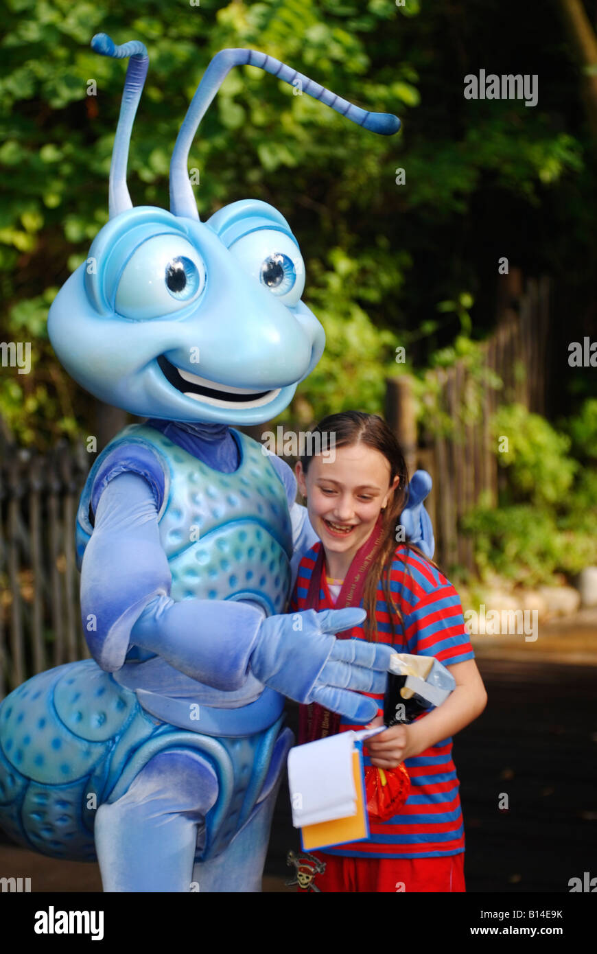 young happy smiling girl hugging ant character at Disneyland Stock ...