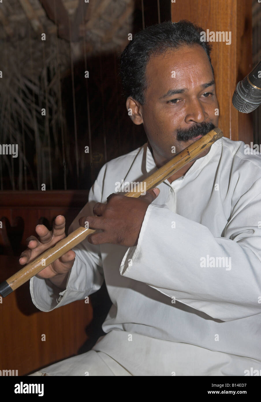Man playing traditional Indian bamboo flute Kerala India Stock Photo ...