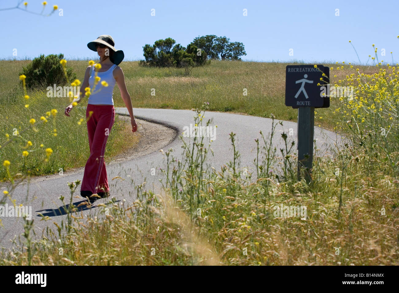 beautiful girl walking on a recreation path Stock Photo - Alamy