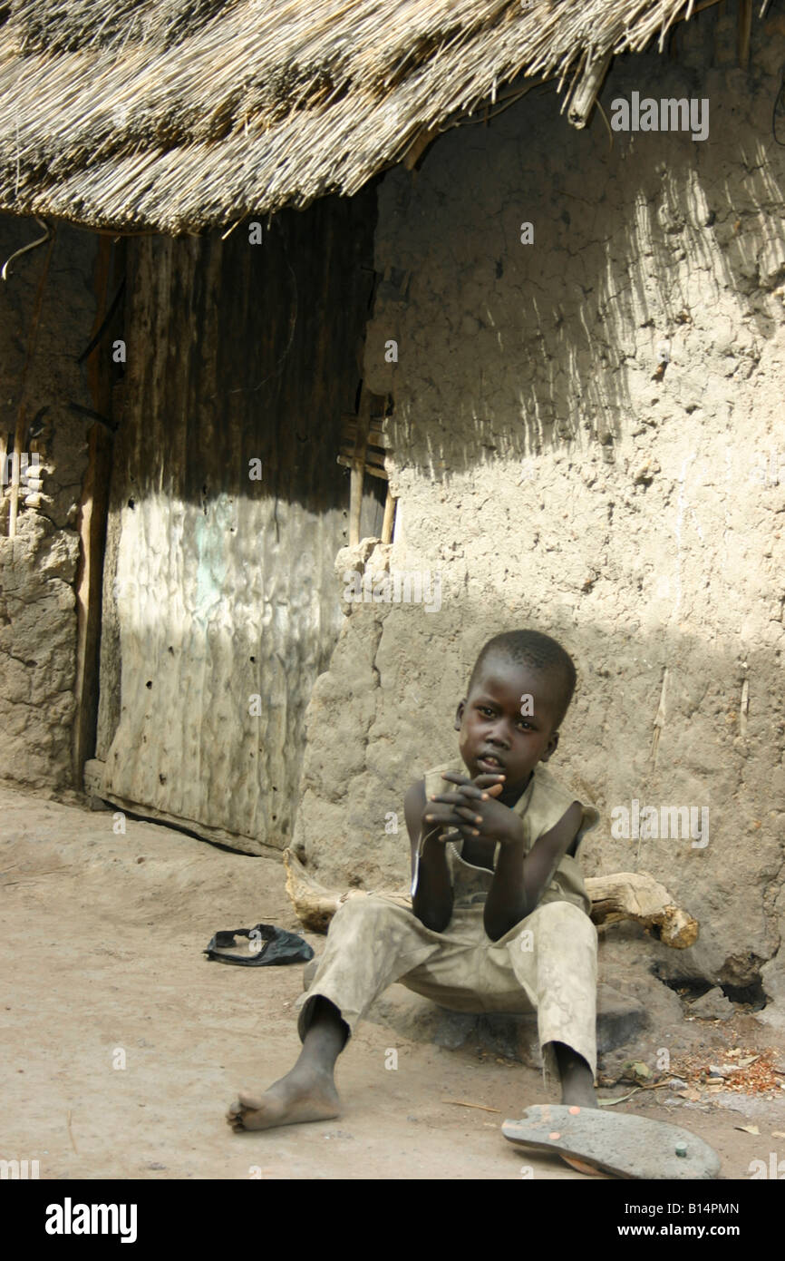 Boy sitting in front of a hut ("tukul") in the Rumbek market, South ...