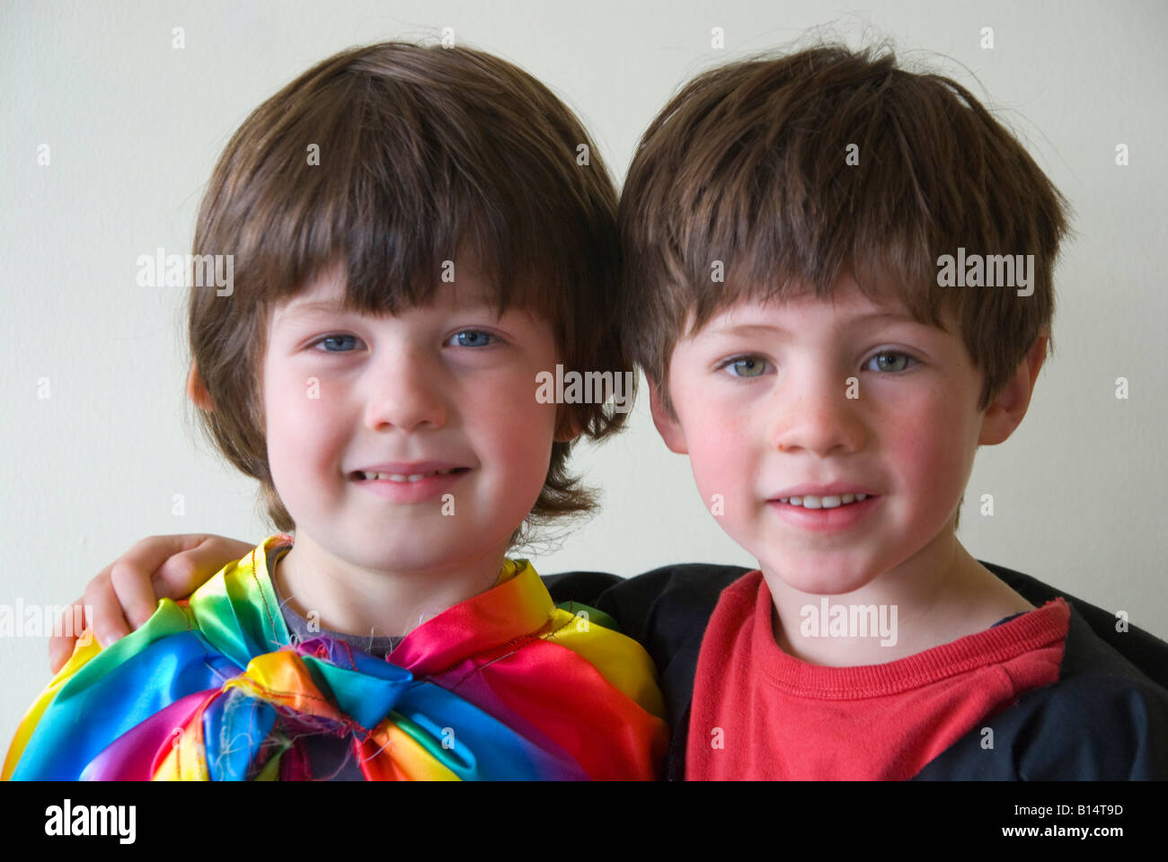 Two young friends wearing rainbow coloured clothing for fancy dress up ...