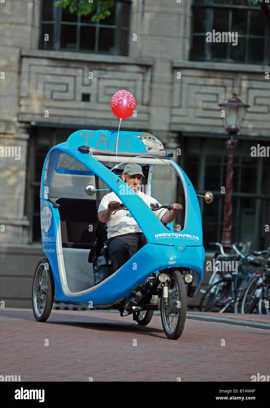 Tricycle taxi, with solo driver, in Amsterdam Stock Photo - Alamy