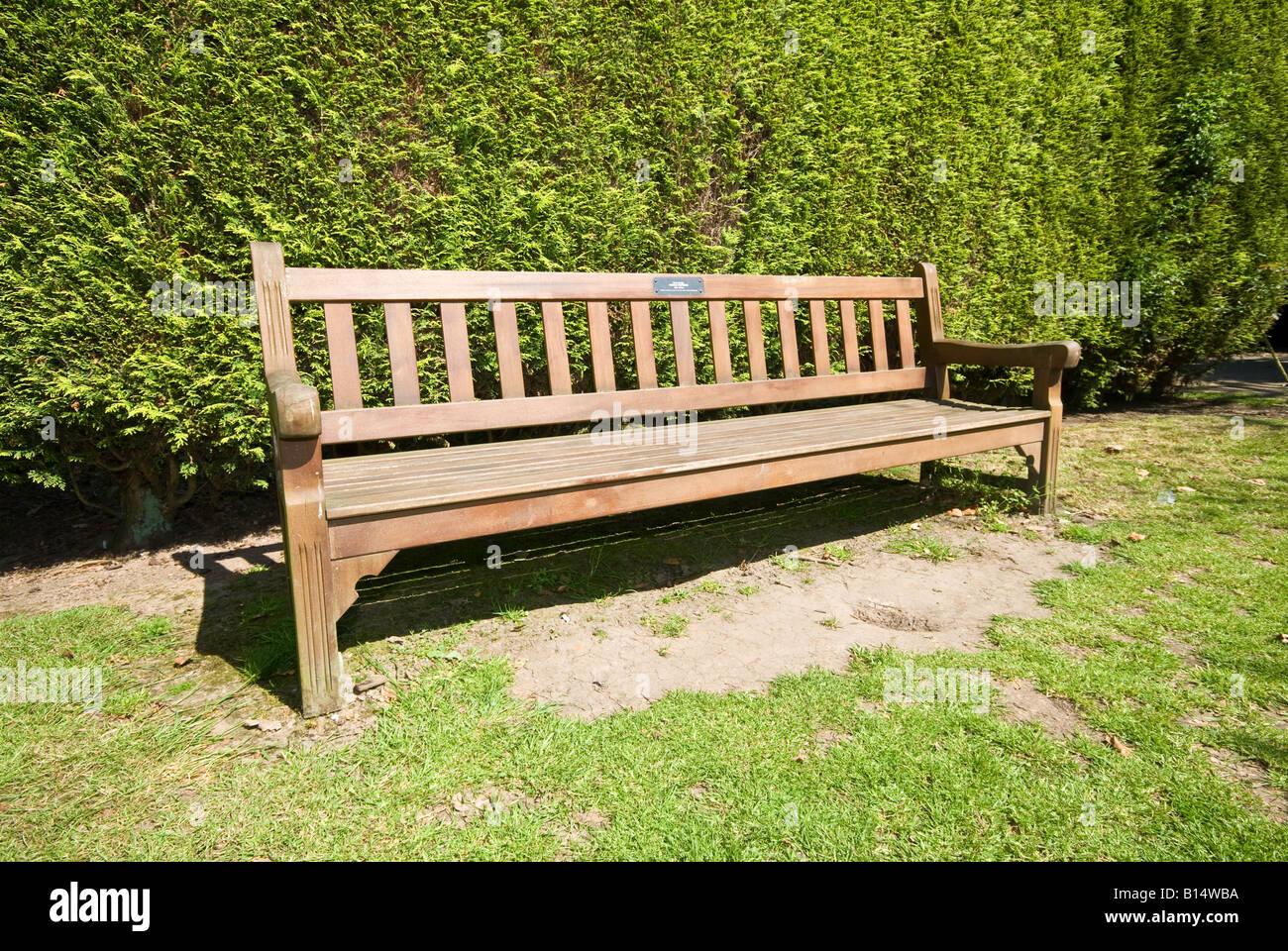 Wooden park bench with green surroundings in Walton Gardens, Walton ...
