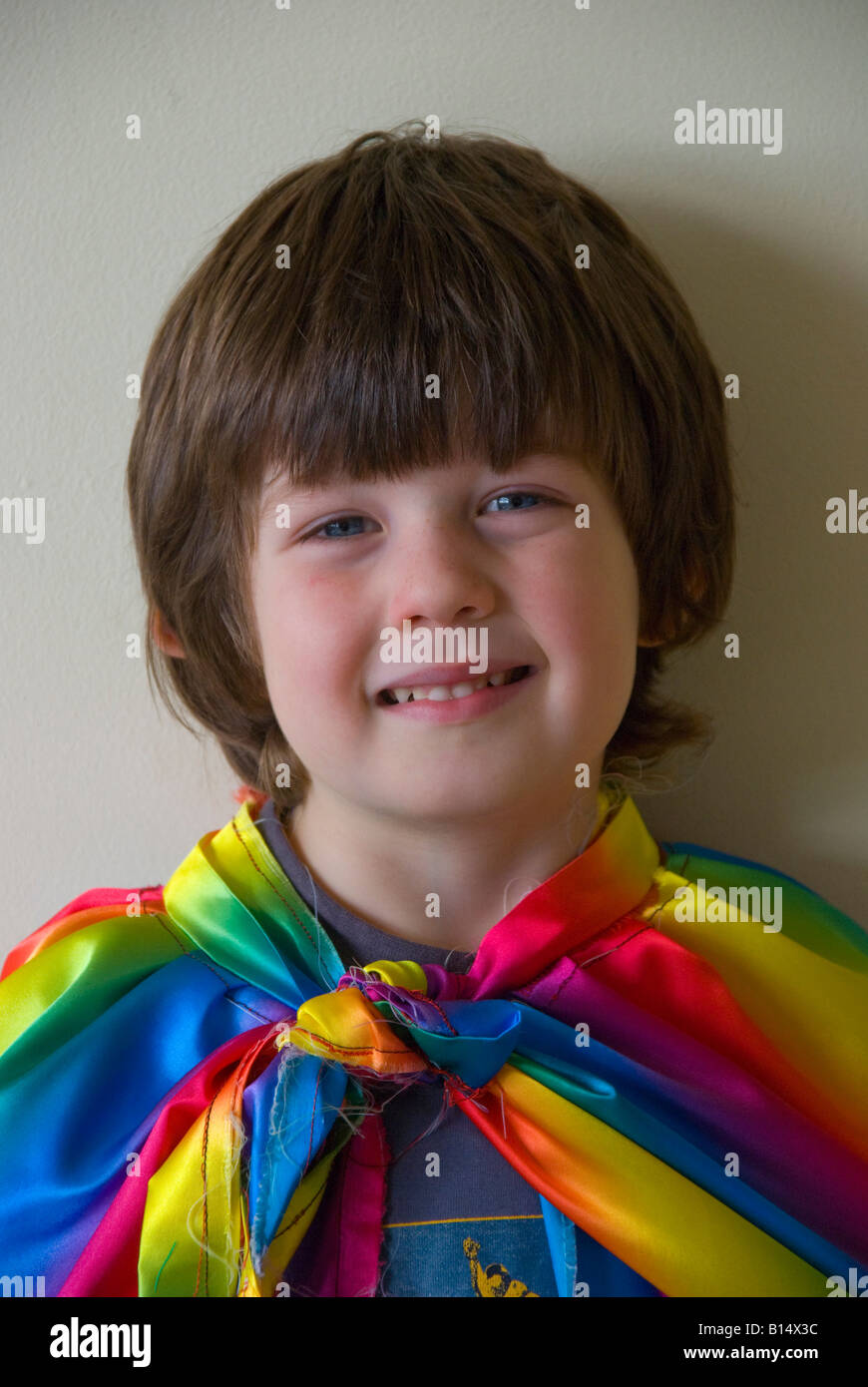 A boy ina rainbow colored cape smiling Stock Photo - Alamy