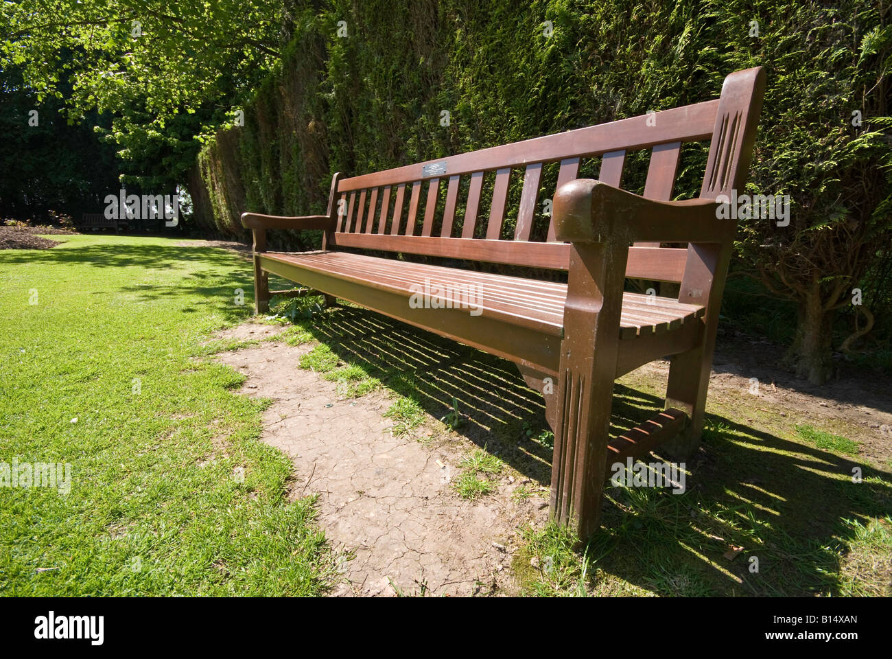 Wooden park bench with green surroundings in Walton Gardens, Walton ...