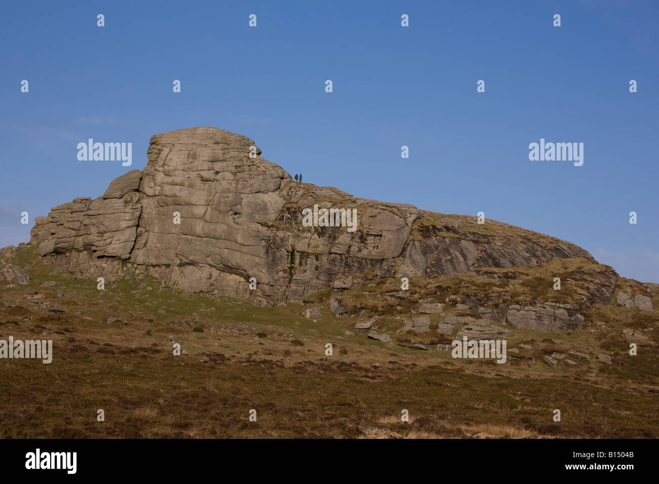 Haytor Rock with tiny figures on top Stock Photo - Alamy