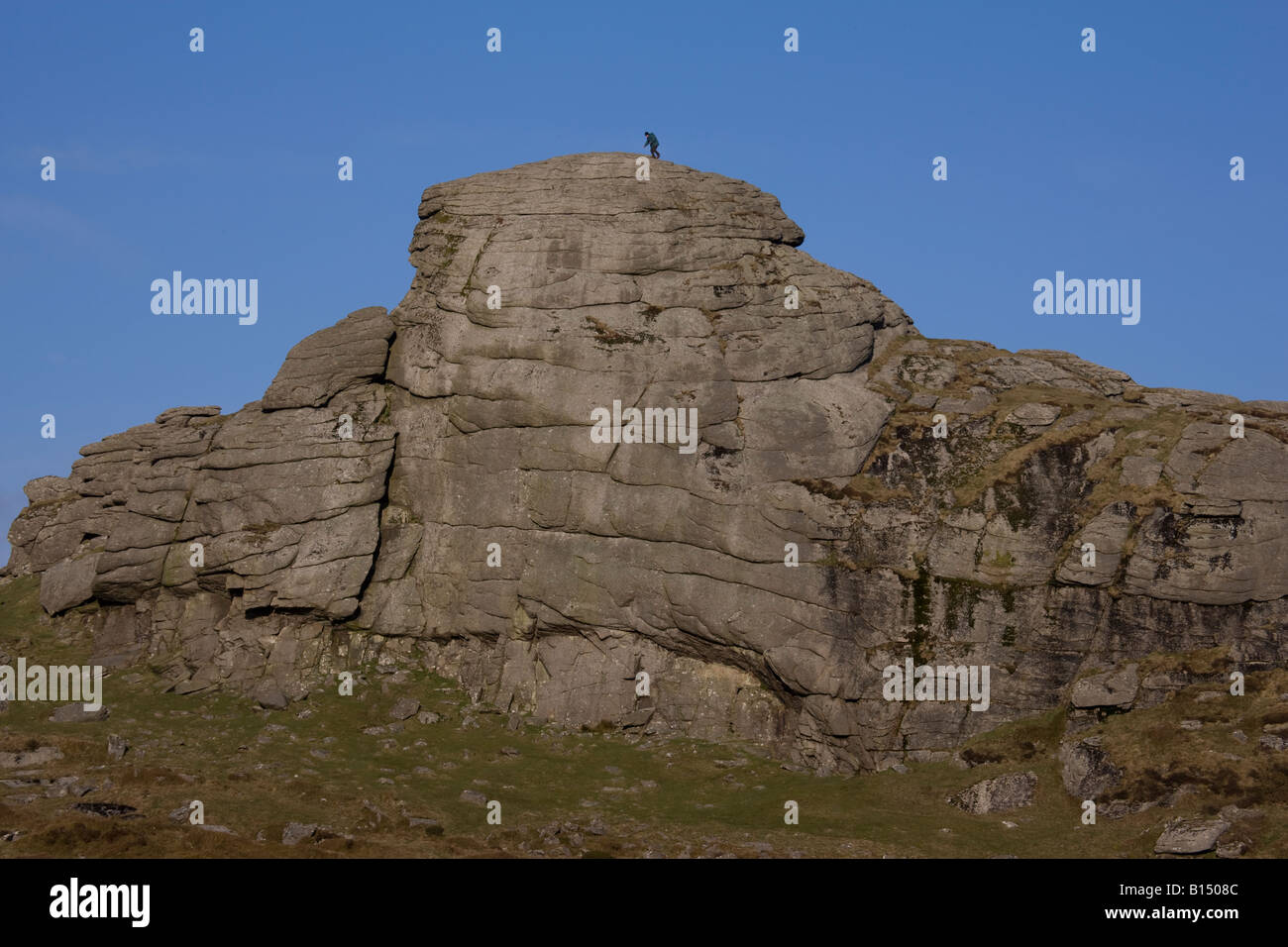 Haytor Rock with tiny figure on top Stock Photo - Alamy