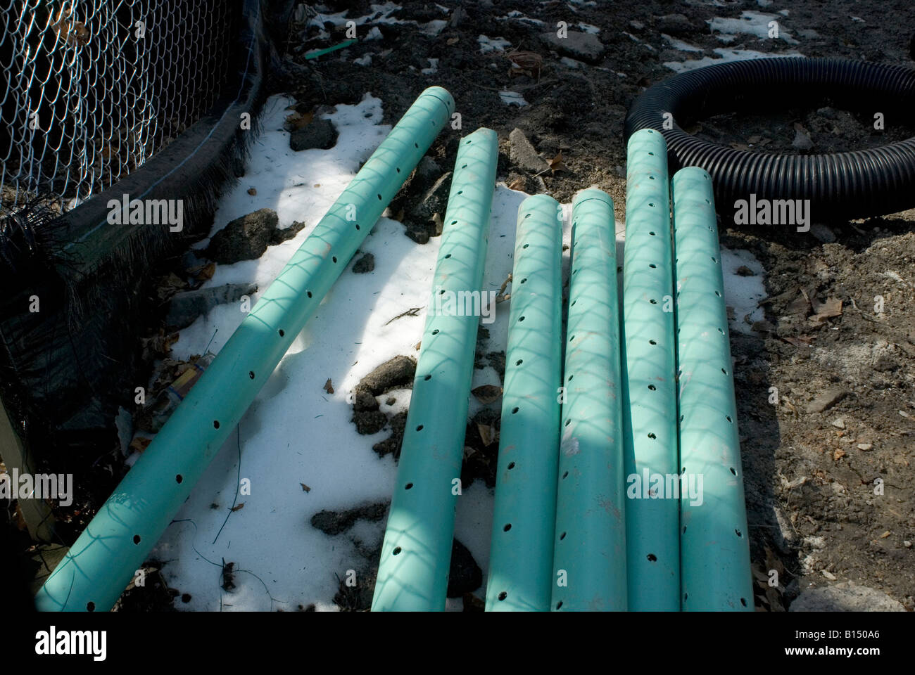 Green pipes lying on a construction site waiting to be used Stock Photo ...