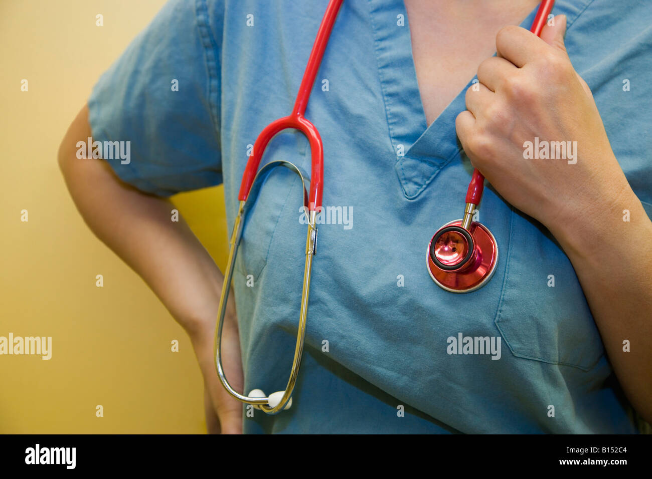 Doctor standing with stethoscope Stock Photo - Alamy
