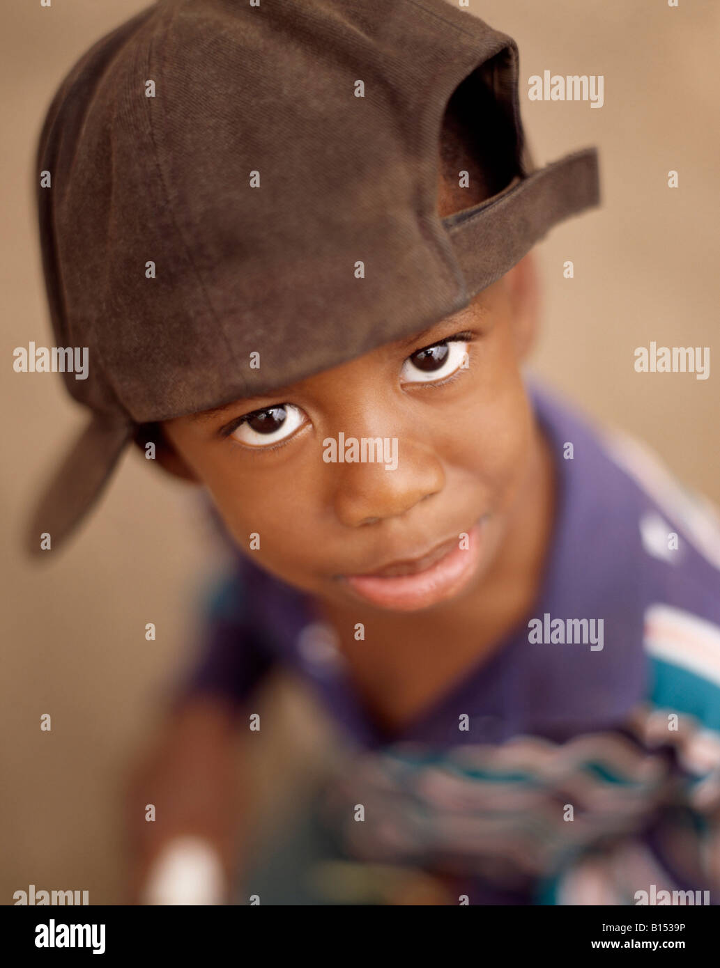Boy wearing baseball cap and pouting Stock Photo - Alamy