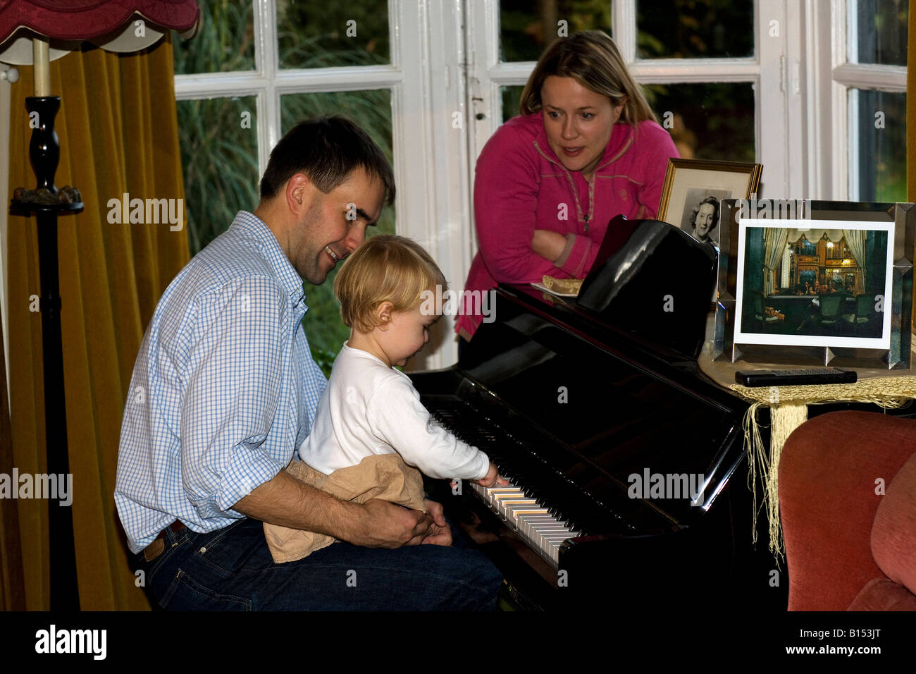 Child learning to play piano Stock Photo - Alamy