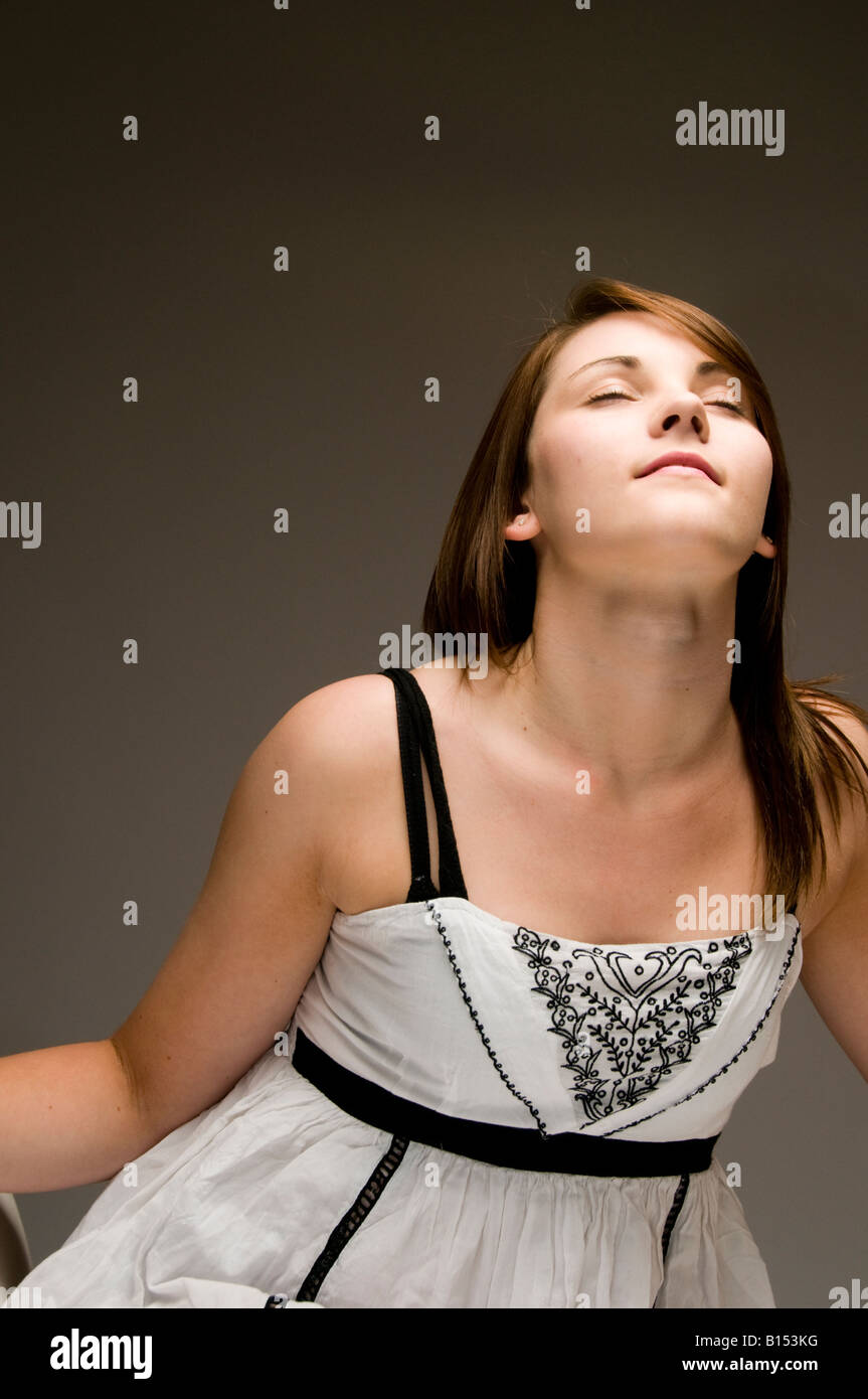 attractive slim teenage girl in studio - eyes closed , face upwards ...