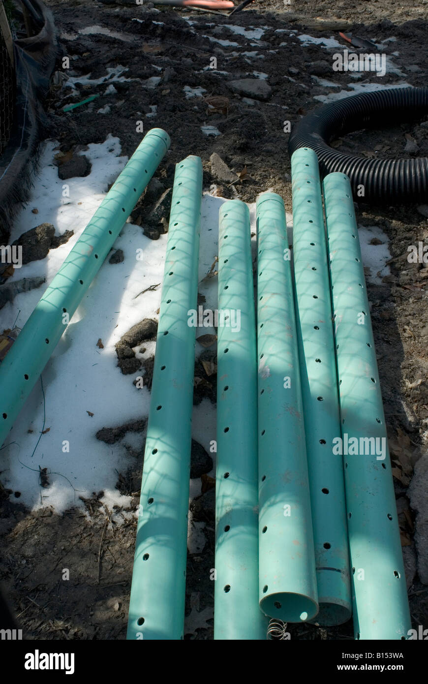 Green pipes lying on a construction site waiting to be used Stock Photo ...