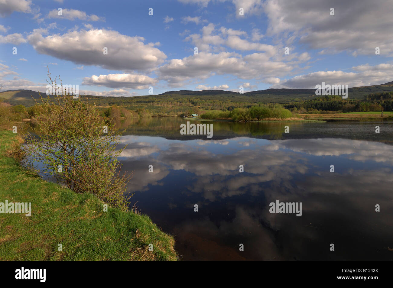Wide peaceful River Lochay with tree-lined riverbanks near its junction ...