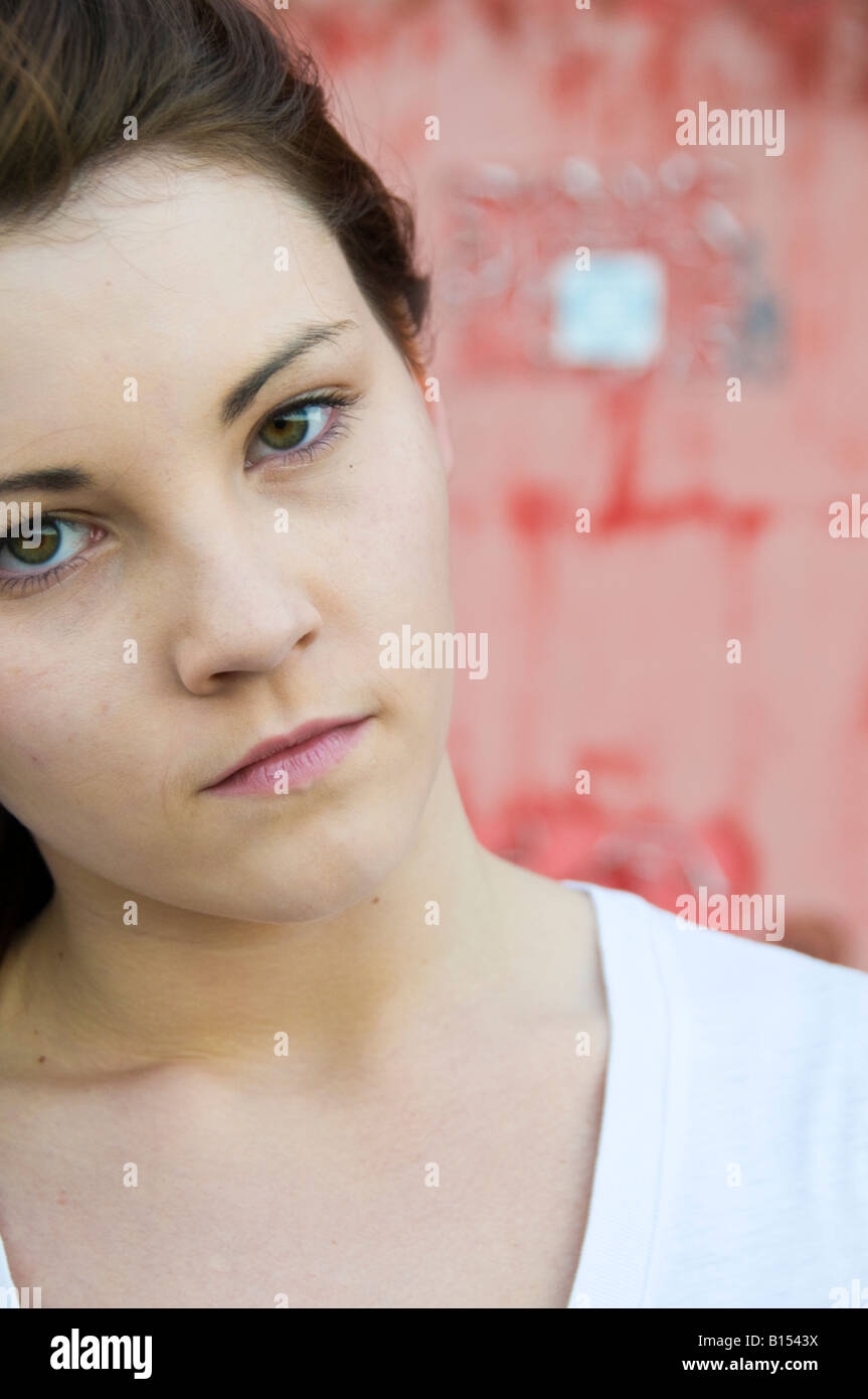 The face of a moody stroppy staring confrontational teenage girl ...