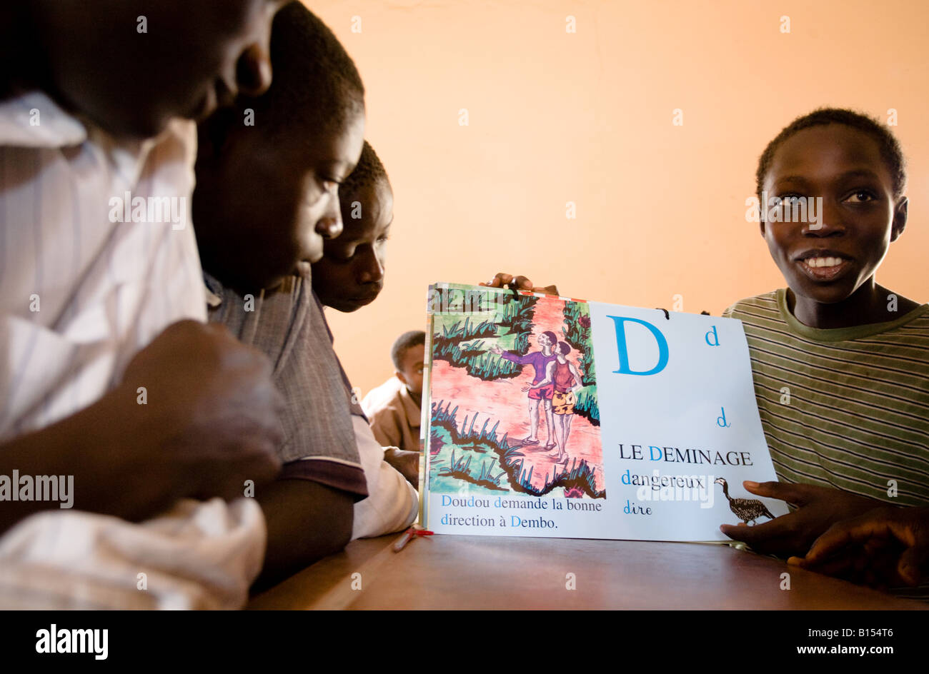 Students look at a visual dictionary during a class on mine awareness ...