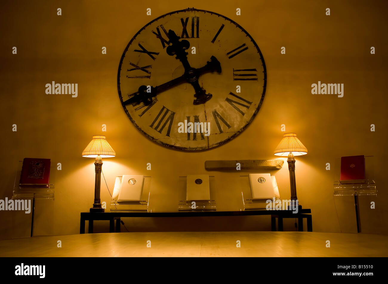 Huge old wall clock in an illuminanted ancient studio Stock Photo - Alamy