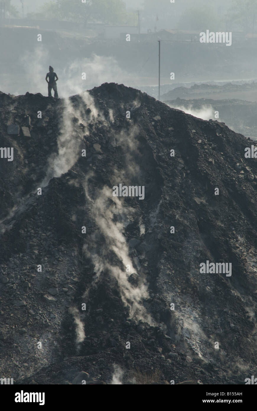 Smoke and steam rise from coking pits at an opencast mine near Dhanbad ...
