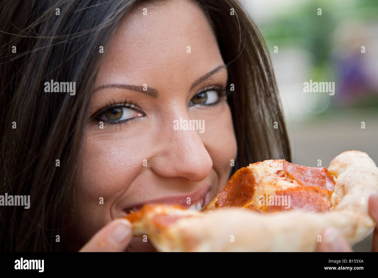 Young happy woman eating pizza hi-res stock photography and images - Alamy