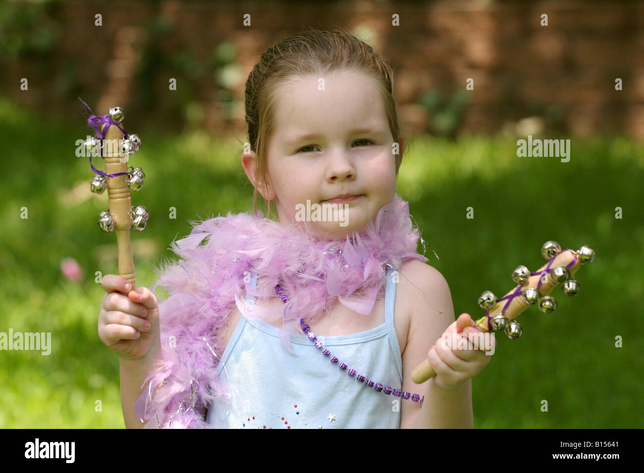 Young girl plays dress up while playing the jingle bells Stock Photo ...