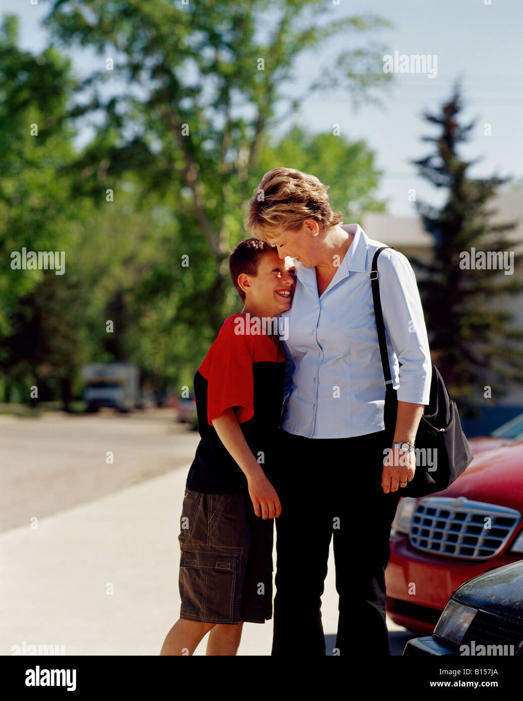 Woman smiling and hugging son Stock Photo - Alamy
