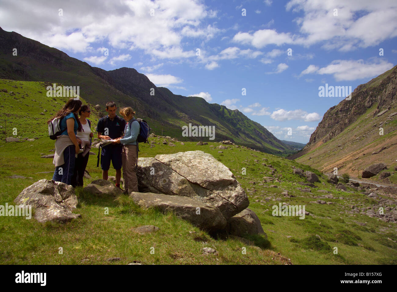 A group of walkers map reading in the mountains Stock Photo - Alamy