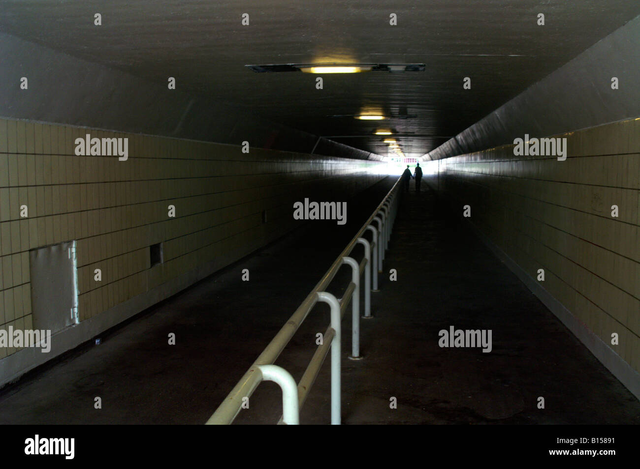 Dark subway passage underway underground tunnel with two couple lower ...