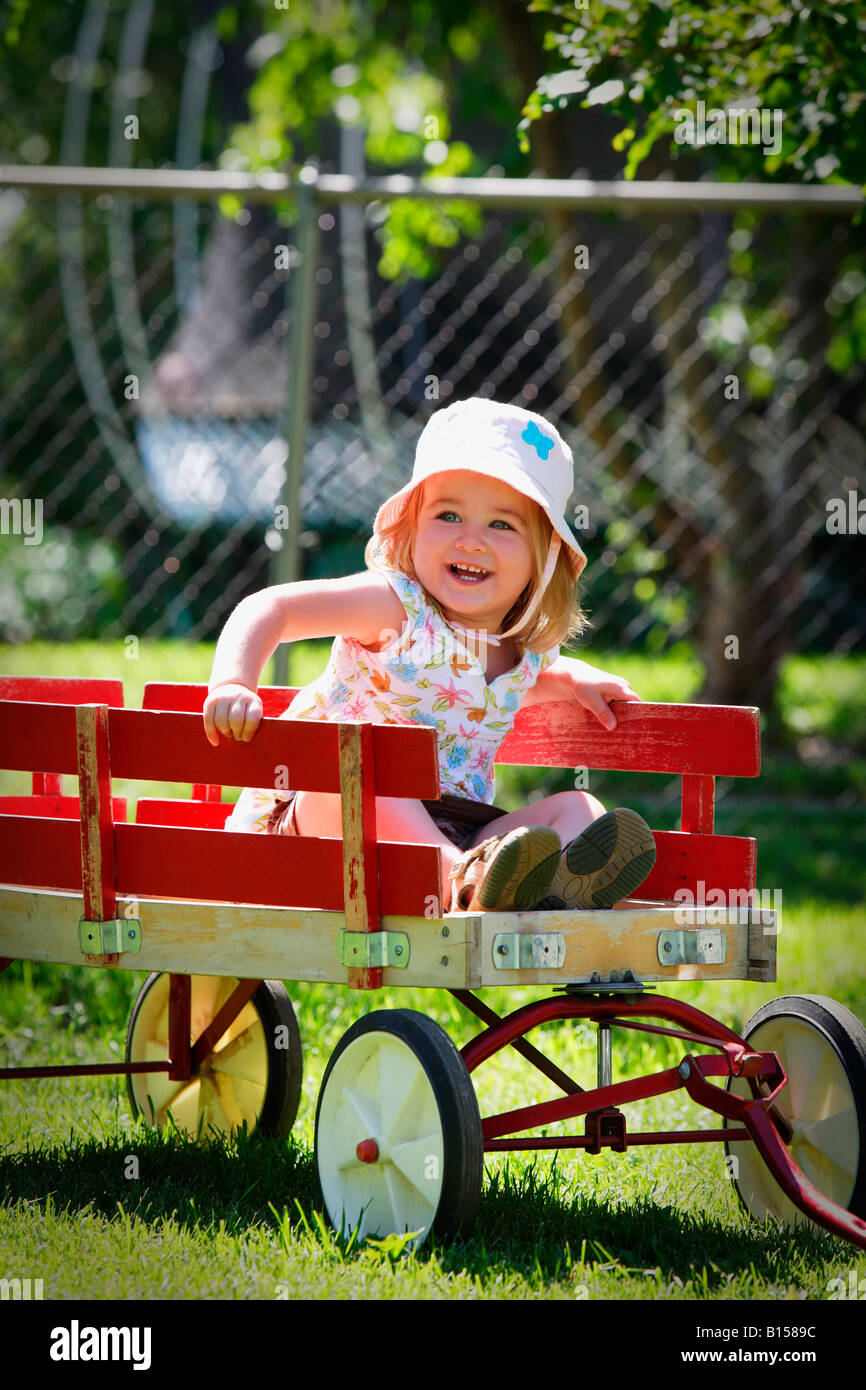 Girl sitting in wagon Stock Photo - Alamy