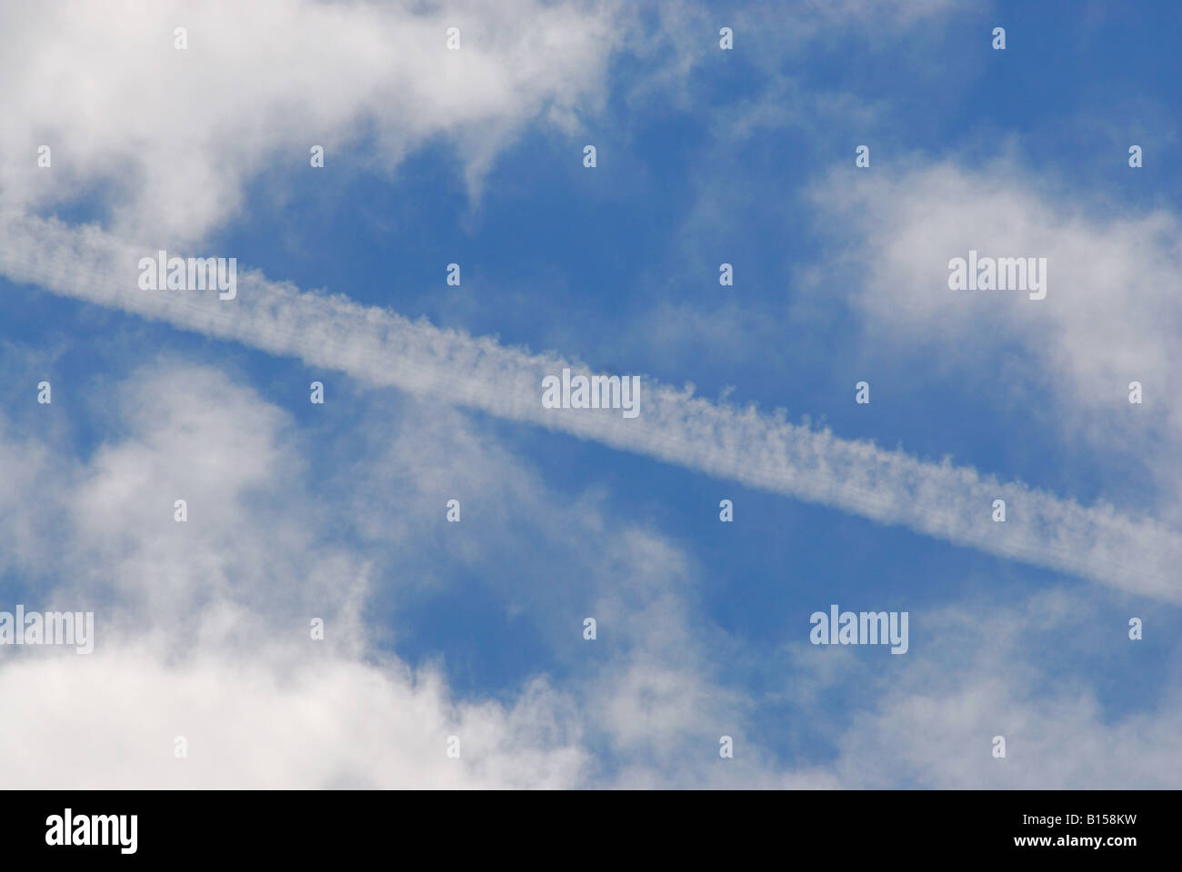 vapor trails or chemtrails from jets in sky often forming grid or ...