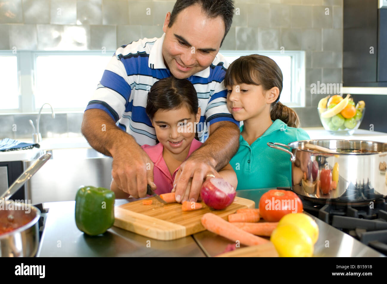 Father cooking with his children Stock Photo - Alamy