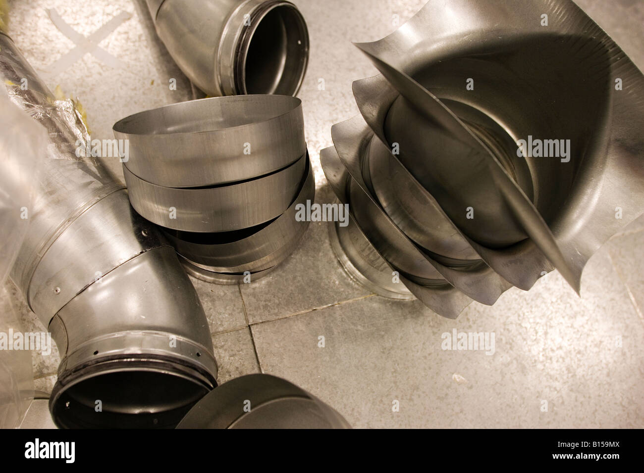 Parts of air ducts lie on the floor, awaiting installation Stock Photo ...