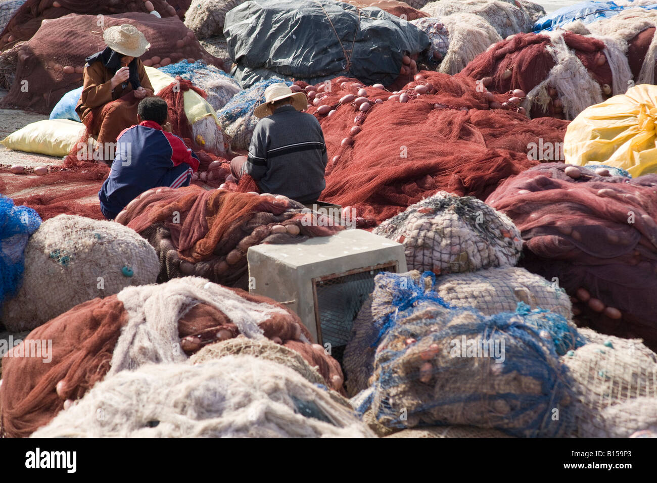 Fishermen repair their nets hi-res stock photography and images - Alamy